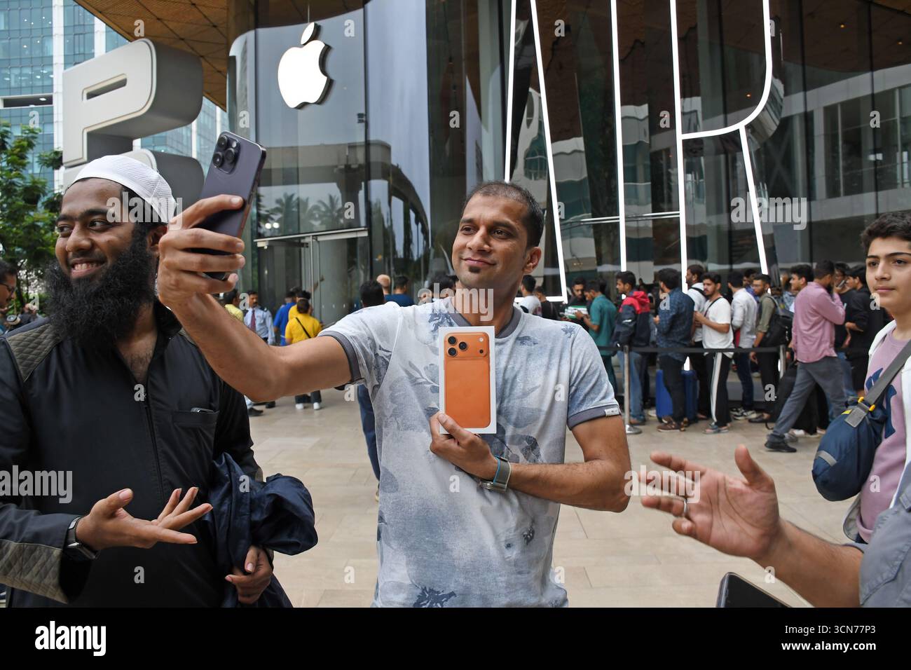 A man clicks a selfie holding a box of newly purchase iPhone 17 mobile ...