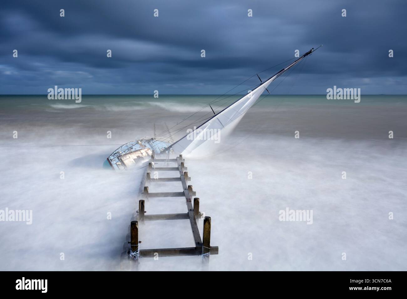 A sail boat during a long exposure being smashed up on the groynes at ...