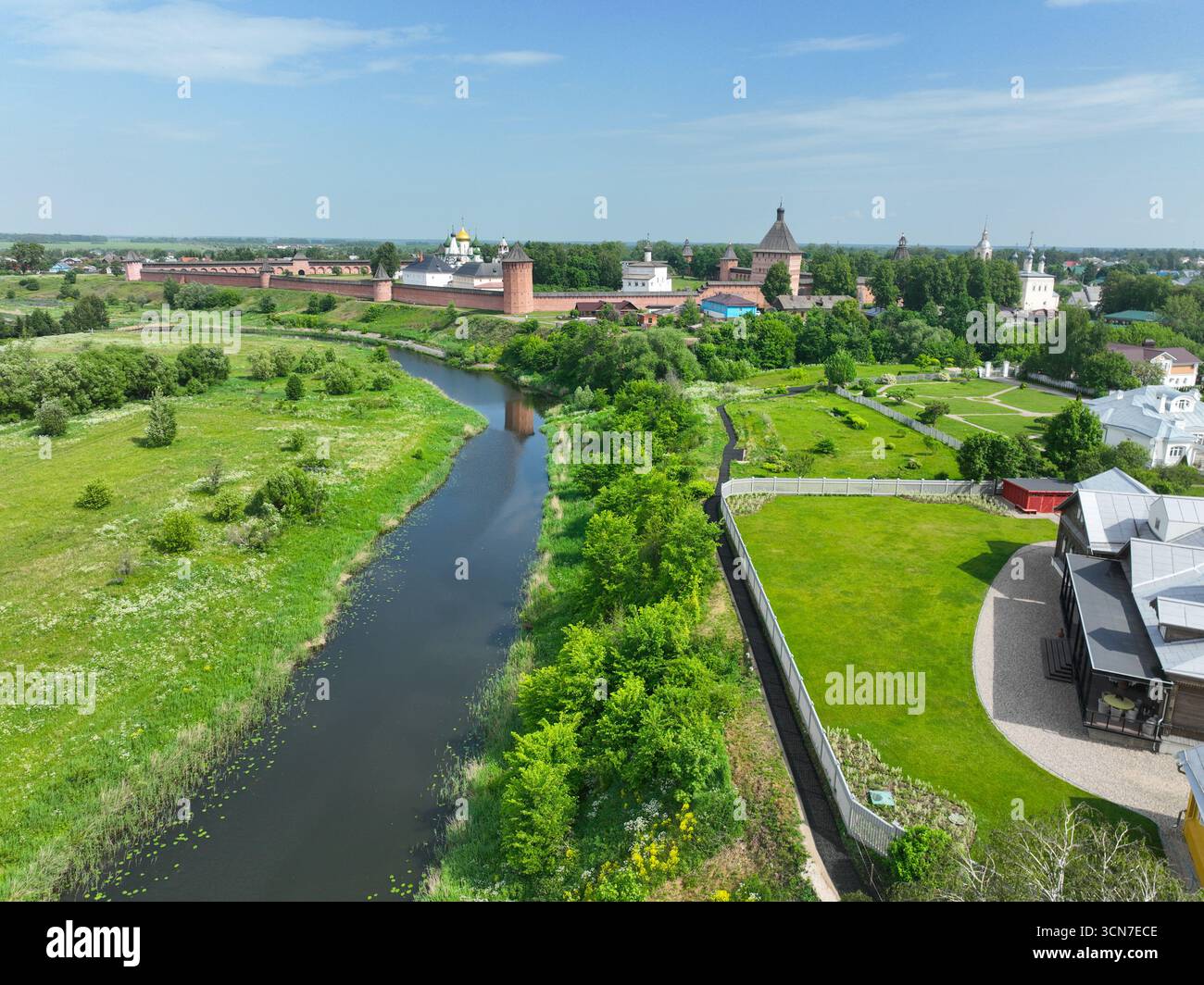 An aerial view of a large monastery complex with red brick walls and ...