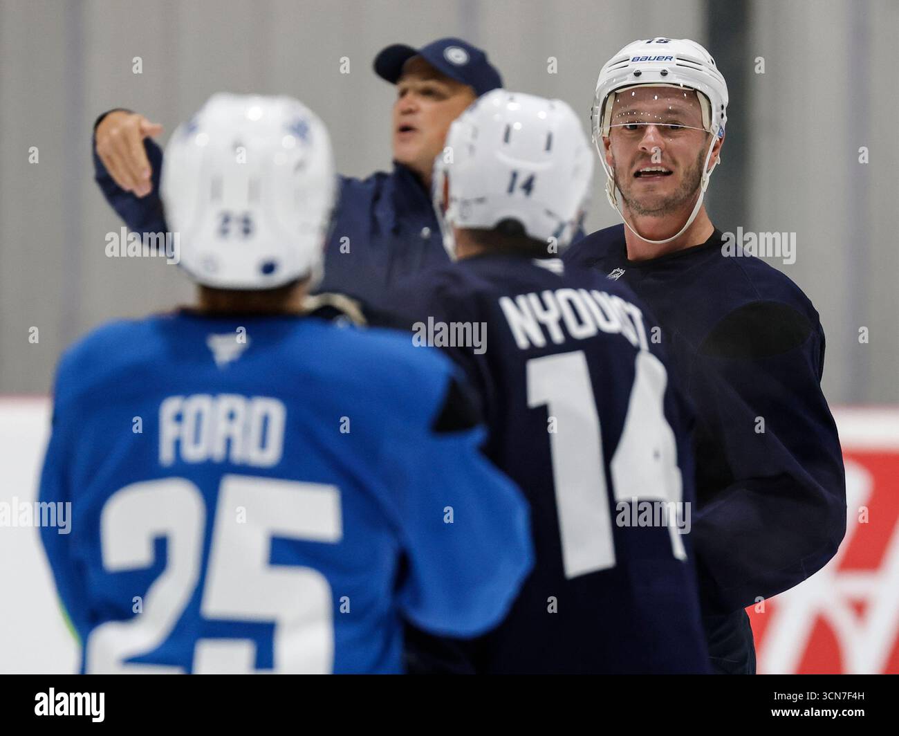 Winnipeg Jets' Jonathan Toews (19) smiles at Parker Ford (25) and ...
