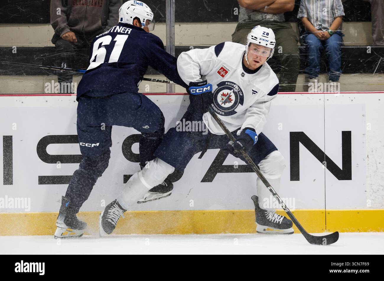 Winnipeg Jets' Ashton Sautner (61) and Jaret Anderson-Dolan (28) battle ...