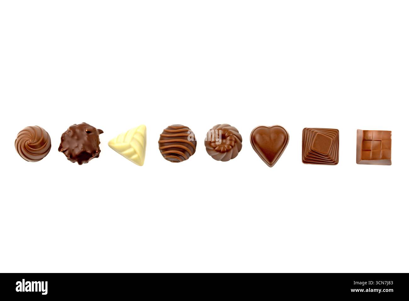 A row of chocolate candies with different shapes and sizes. The candies ...