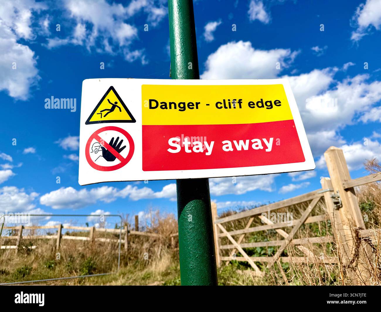 A coastal erosion warning sign on a cliff top in North Yorkshire ...