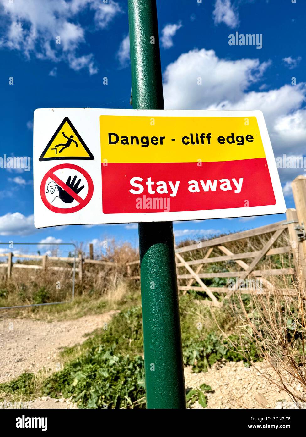 A coastal erosion warning sign on a cliff top in North Yorkshire ...