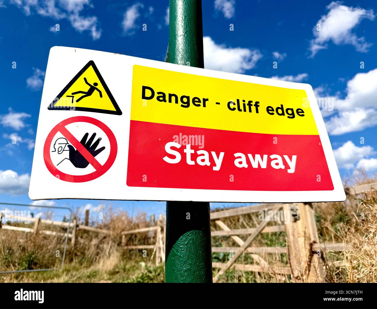 A coastal erosion warning sign on a cliff top in North Yorkshire ...