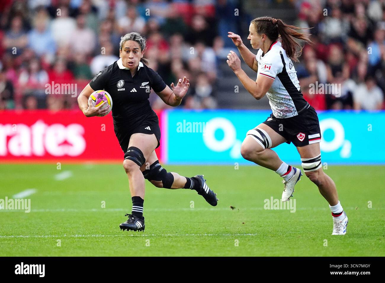 New Zealand's Kennedy Tukuafu (left) goes past Canada's Caroline ...