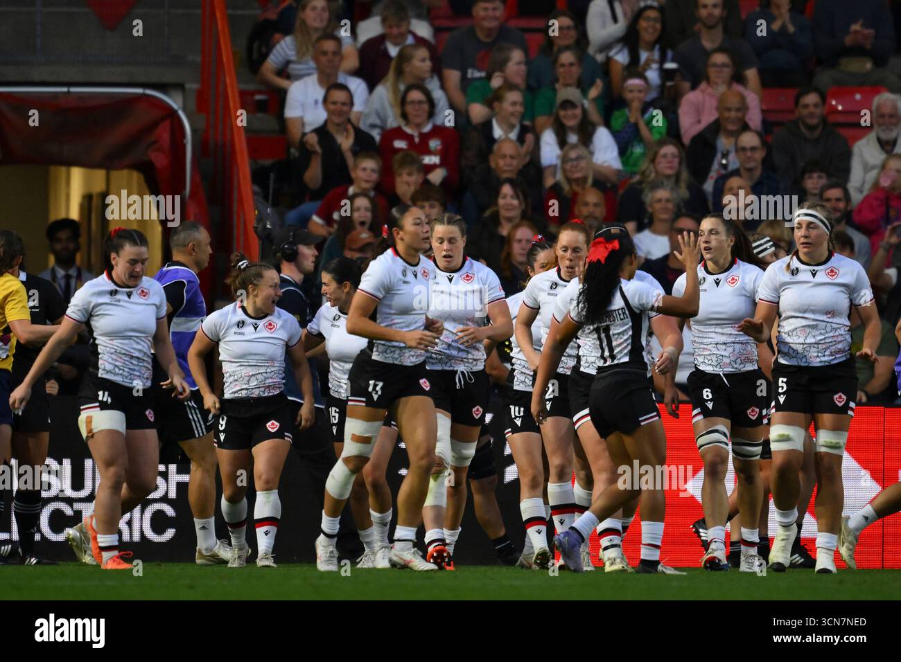 Canada's team players celebrate after scoring their first try during ...