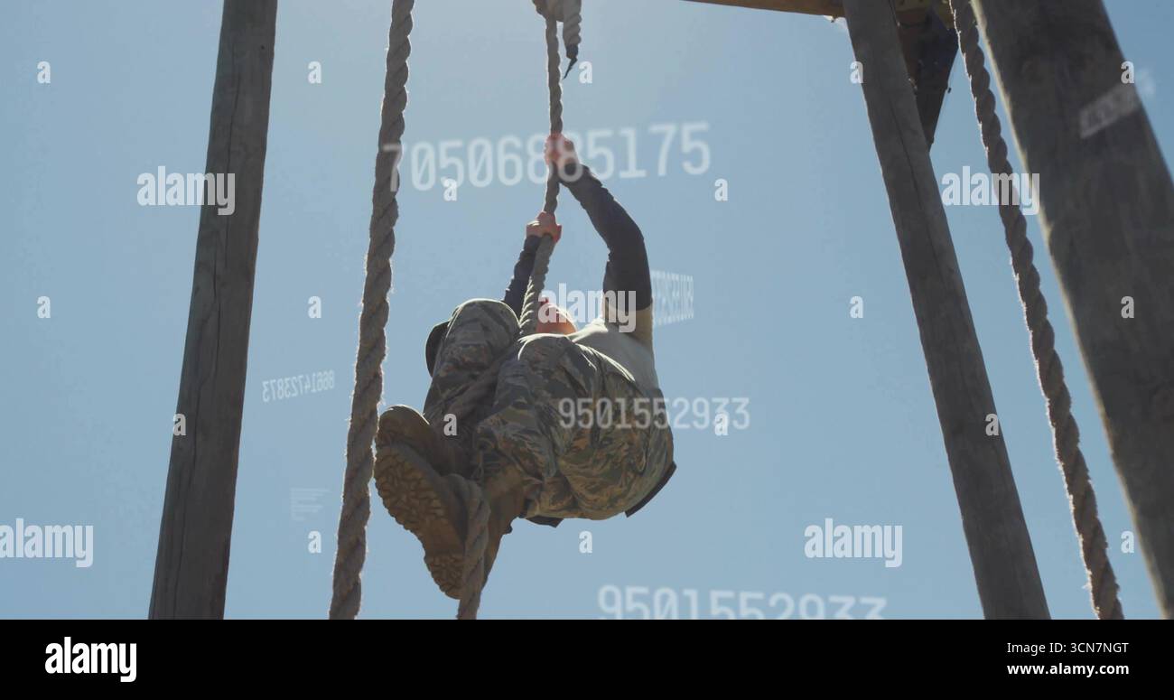 Climbing woman wearing camouflage uniform gripping ropes on outdoor ...
