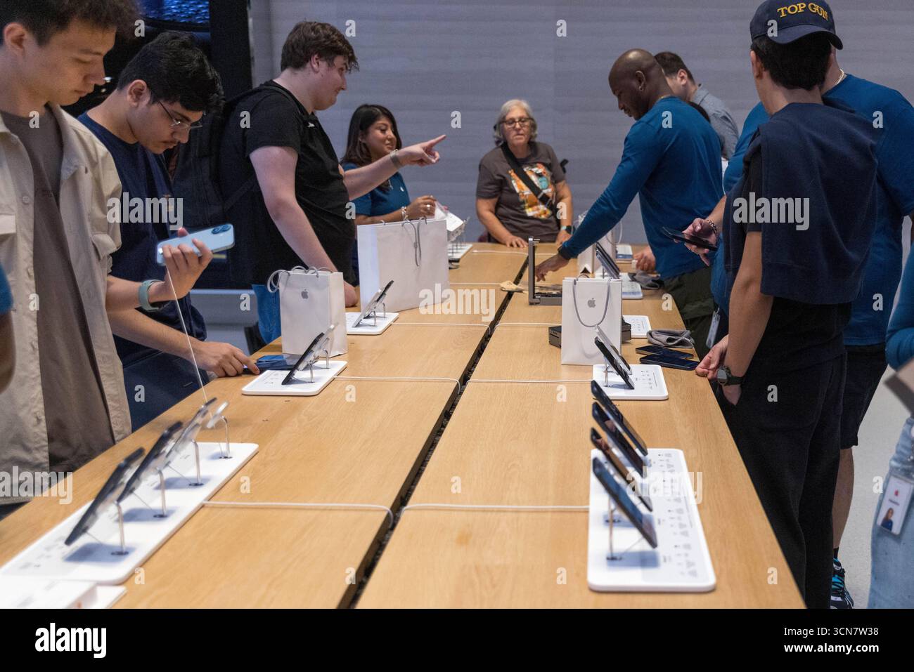 Apple CEO Tim Cook welcomes the first iPhone 17 customers in New York ...