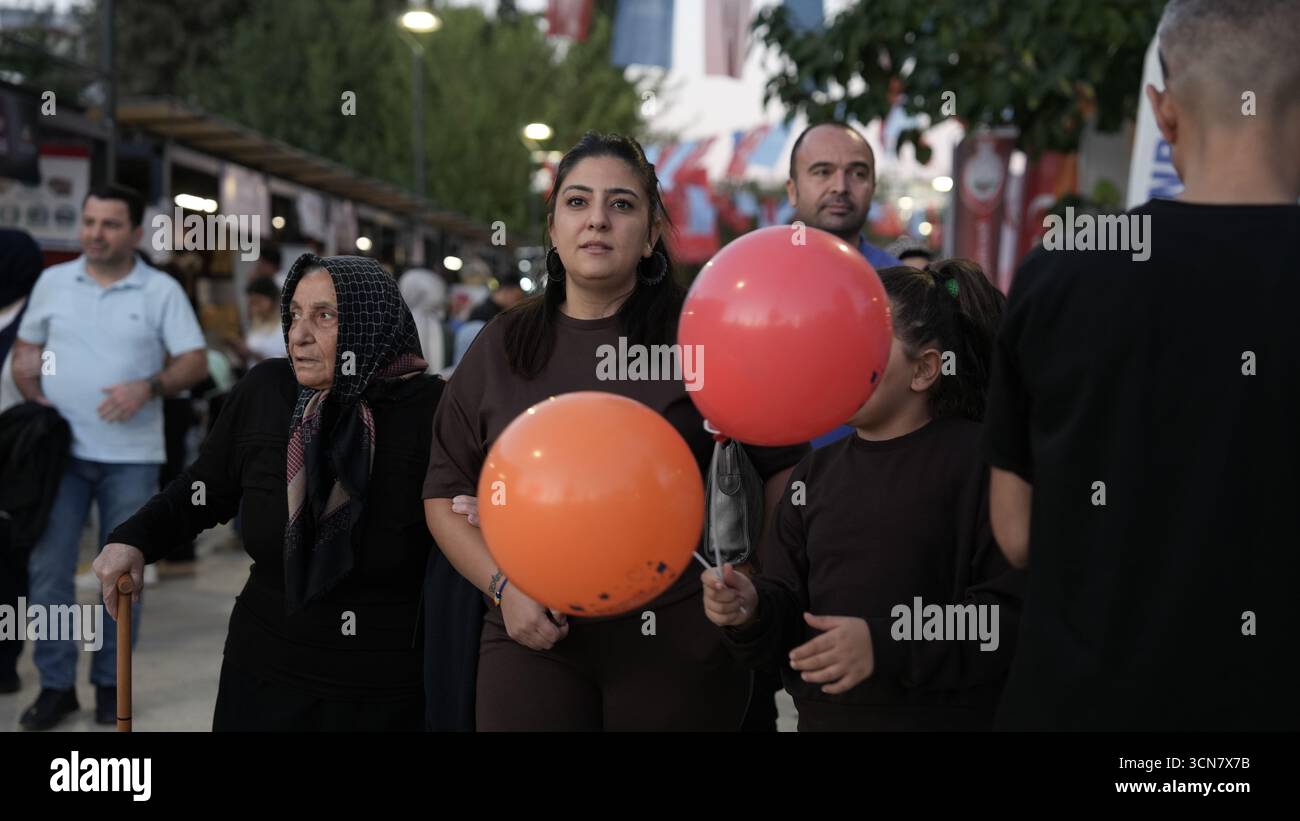 Visitors hold balloons while taking part in family-oriented activities ...