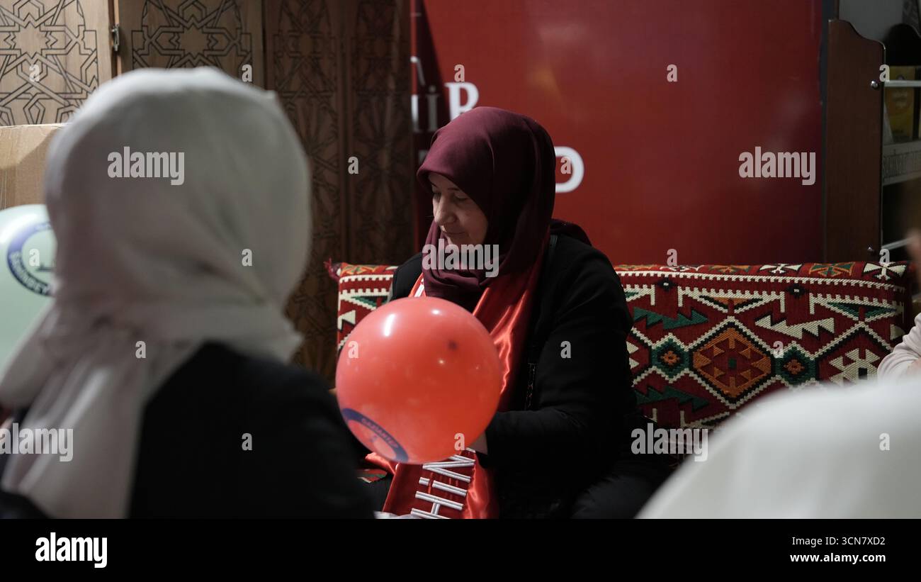 Visitors hold balloons while taking part in family-oriented activities ...