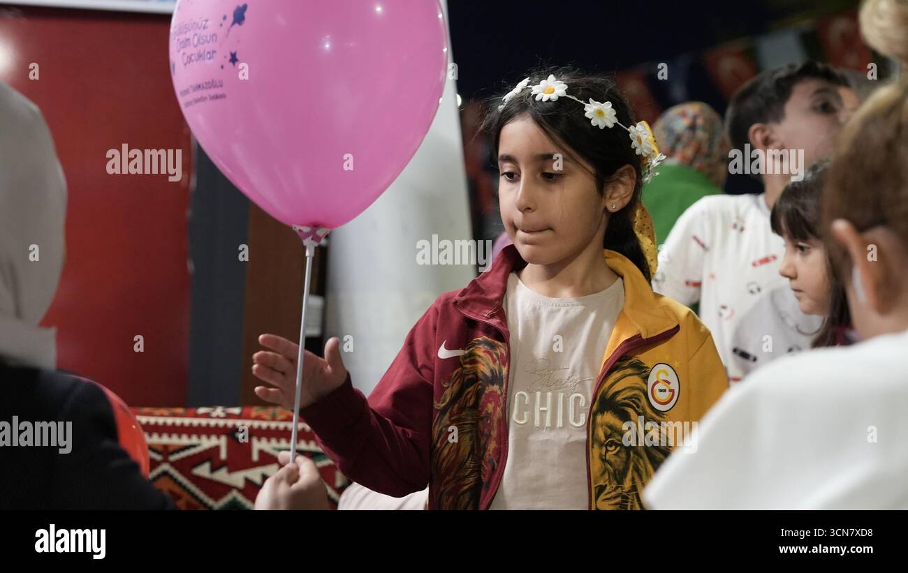 Visitors hold balloons while taking part in family-oriented activities ...