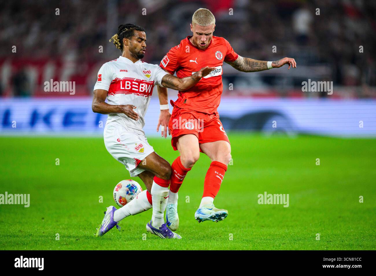 St. Pauli's Louis Oppie, right, and Stuttgart's Lorenz Assignon in ...