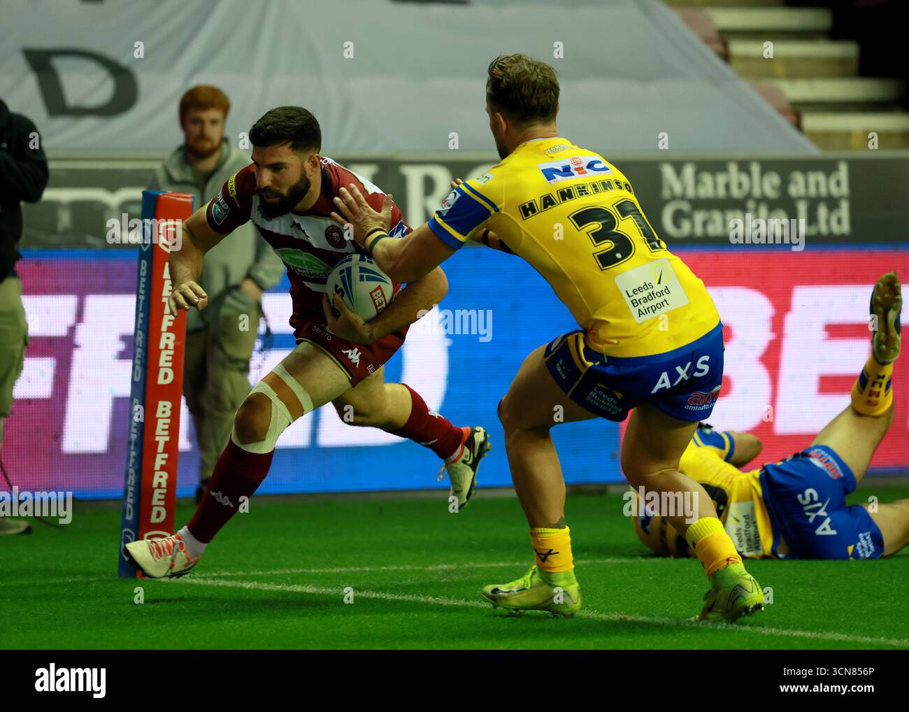 Wigan Warriors' Abbas Miski (left) scores their side's first try of the ...