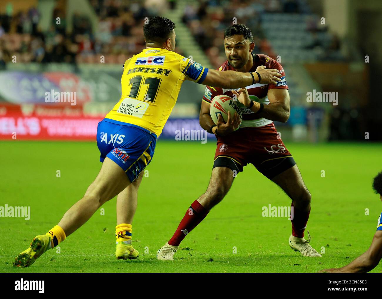 Wigan Warriors Bevan French (right) is tackled by Leeds Rhinos' James ...