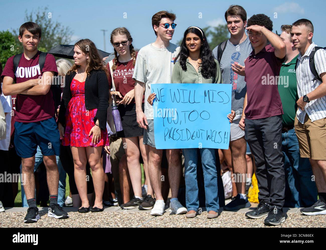 Supporters hold signs during a sendoff for Texas A&M University ...