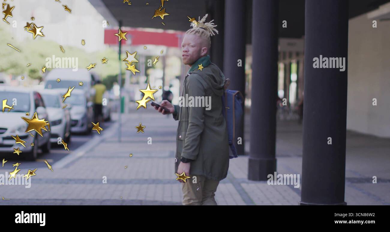 Standing light-skinned man glancing over shoulder on city sidewalk ...
