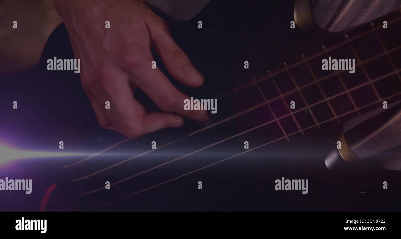 Plucking musician's right hand moving across metal strings bass guitar ...