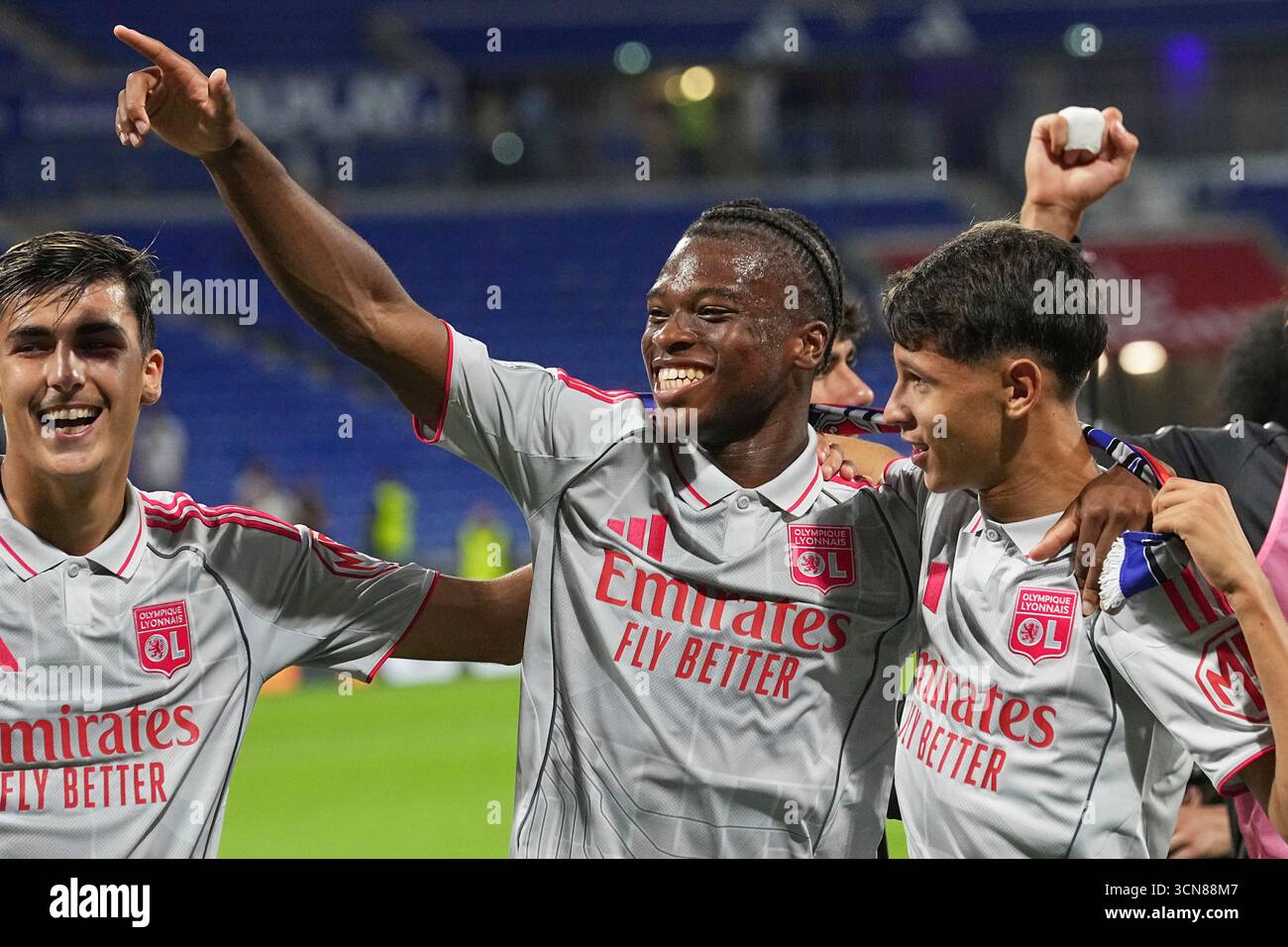 Lyon's Khalis Merah, right, and Lyon's Enzo Molebe, centre, celebrate ...