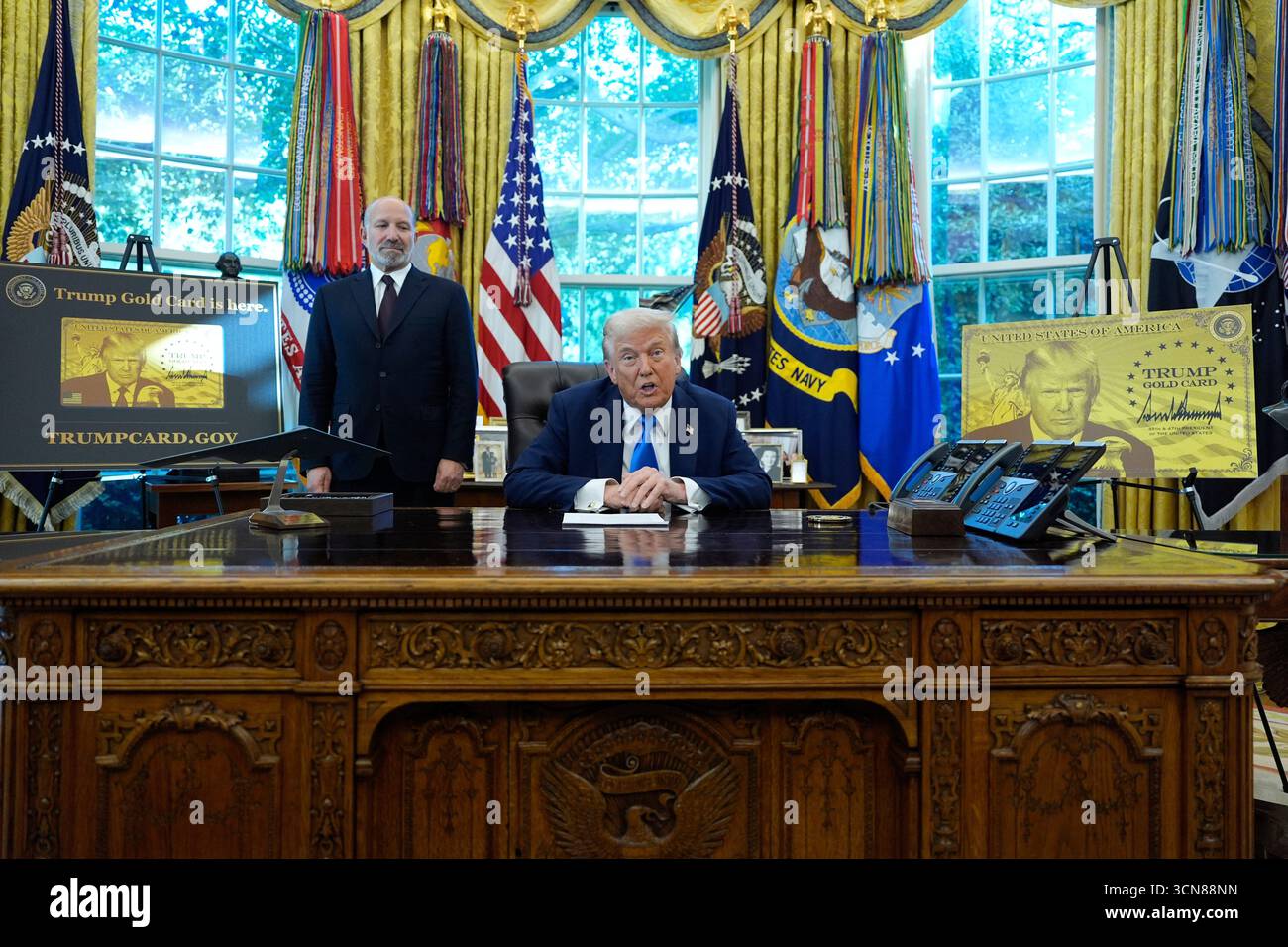 President Donald Trump speaks alongside Commerce Secretary Howard ...