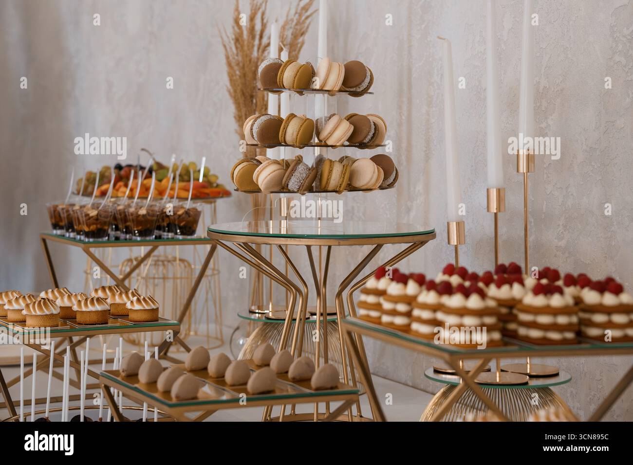 An exquisitely styled dessert buffet features tiered displays ...