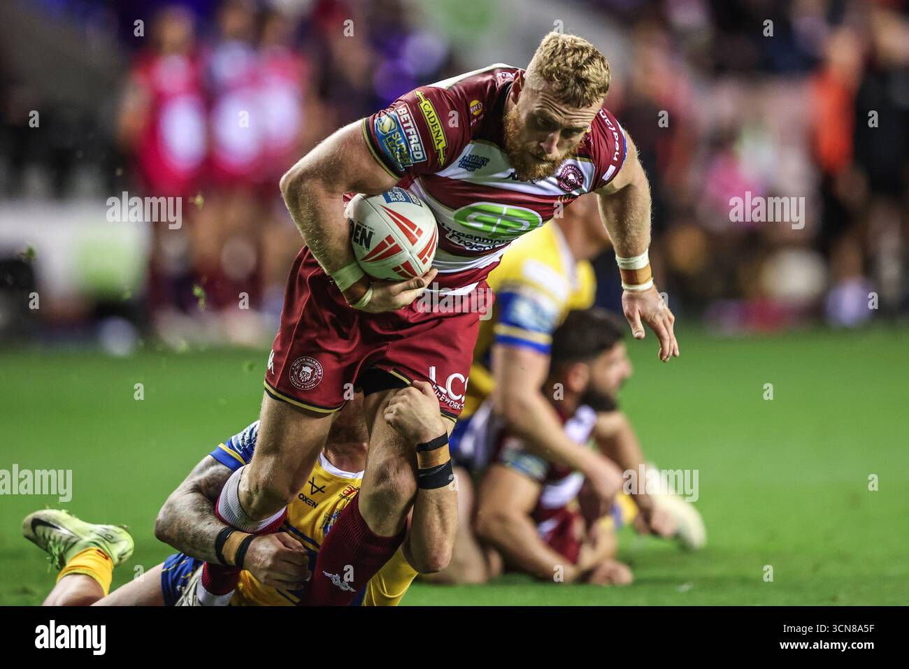 Luke Thompson of Wigan Warriors is tackled during the Betfred Super ...