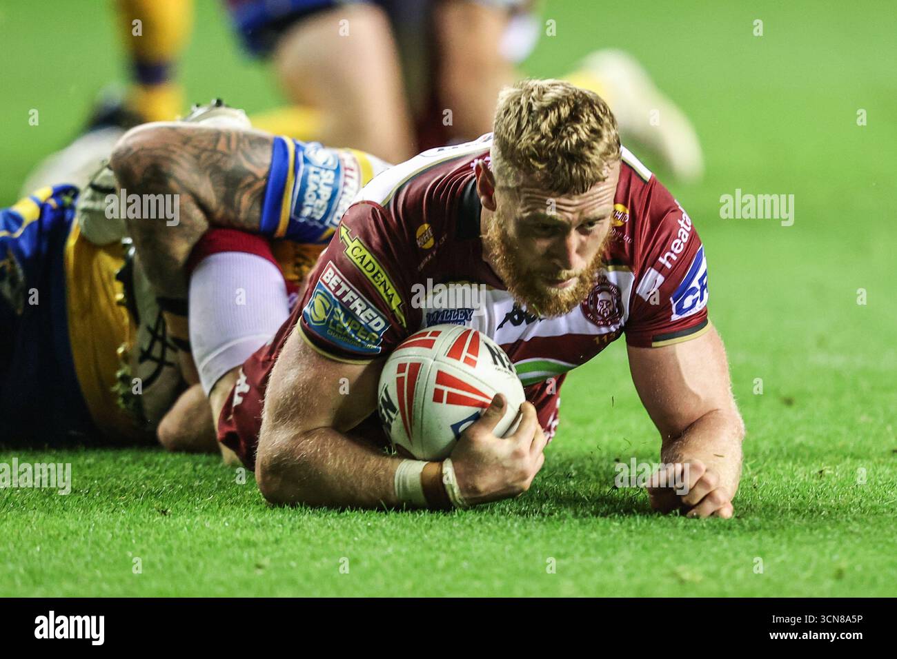 Luke Thompson of Wigan Warriors is tackled during the Betfred Super ...