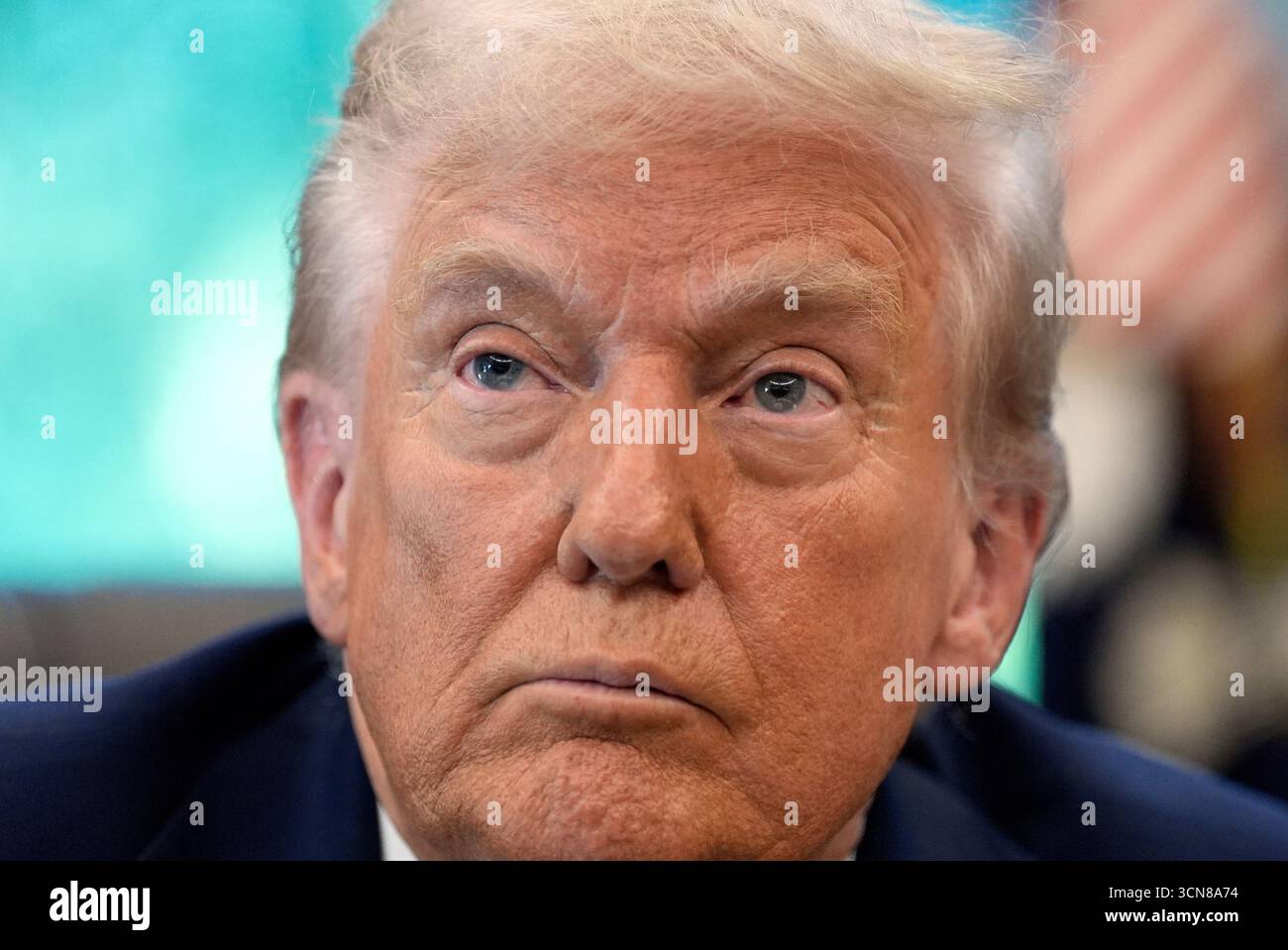 President Donald Trump listens as a reporter asks a question in the ...