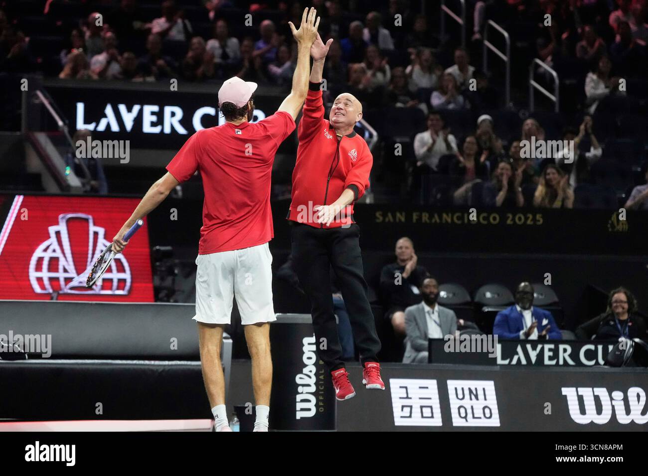 Team World captain Andre Agassi, right, jumps to congratulate Reilly ...