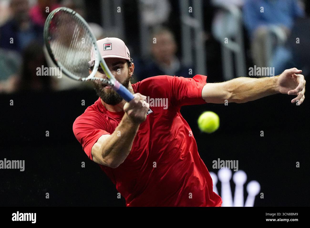 Team World's Reilly Opelka, of the United States, returns a shot ...