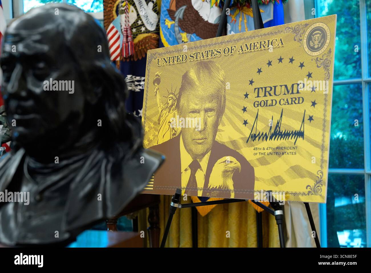 A poster showing the Trump Gold Card is pictured as President Donald ...