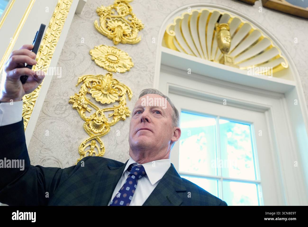 Sean Spicer takes video on a cell phone as President Donald Trump ...