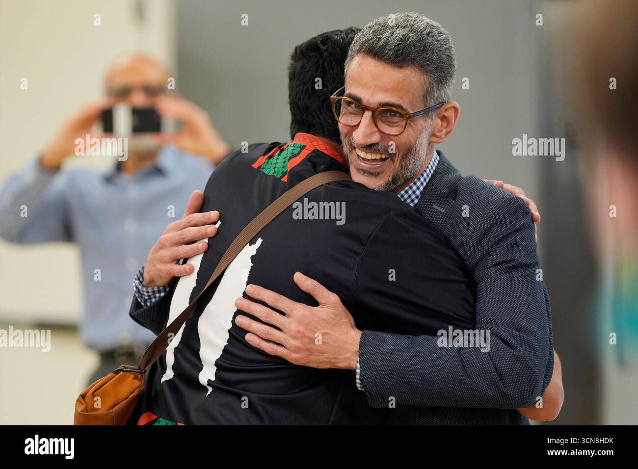 Ayman Soliman is greeted by a supporter as he arrives for a news ...