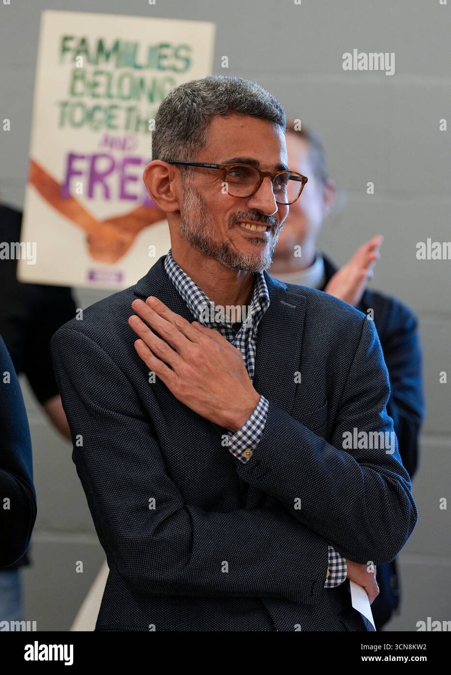 Ayman Soliman is applauded during a news conference at the Clifton ...