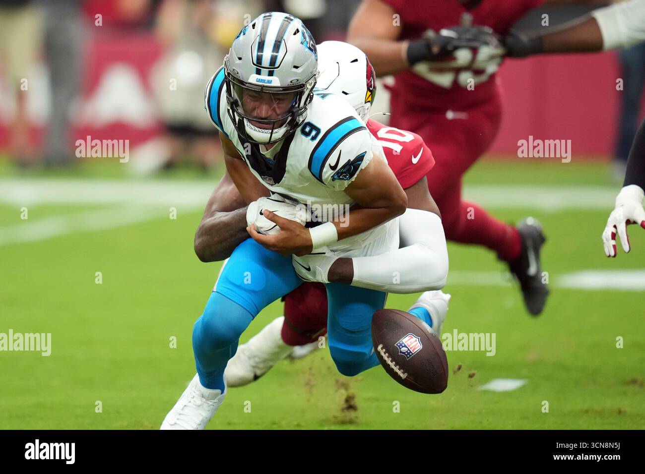 Arizona Cardinals outside linebacker Josh Sweat (10) strips the ball ...