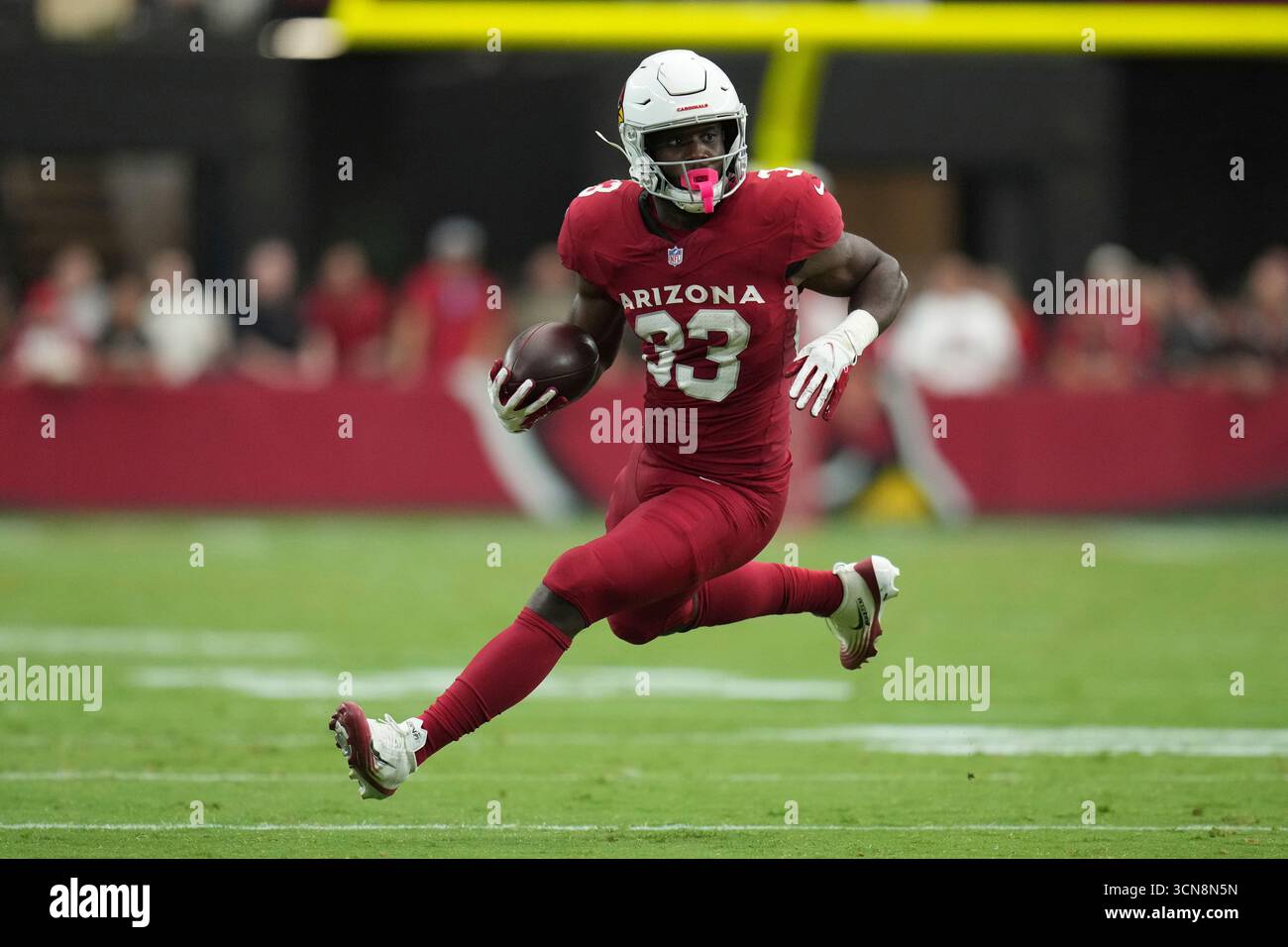 Arizona Cardinals running back Trey Benson (33) runs the ball against ...