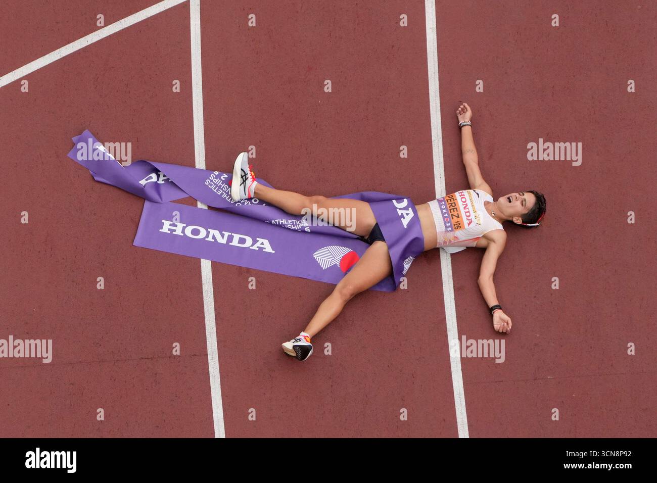 Spain's Maria Perez lays on the track after winning the women's 20 ...