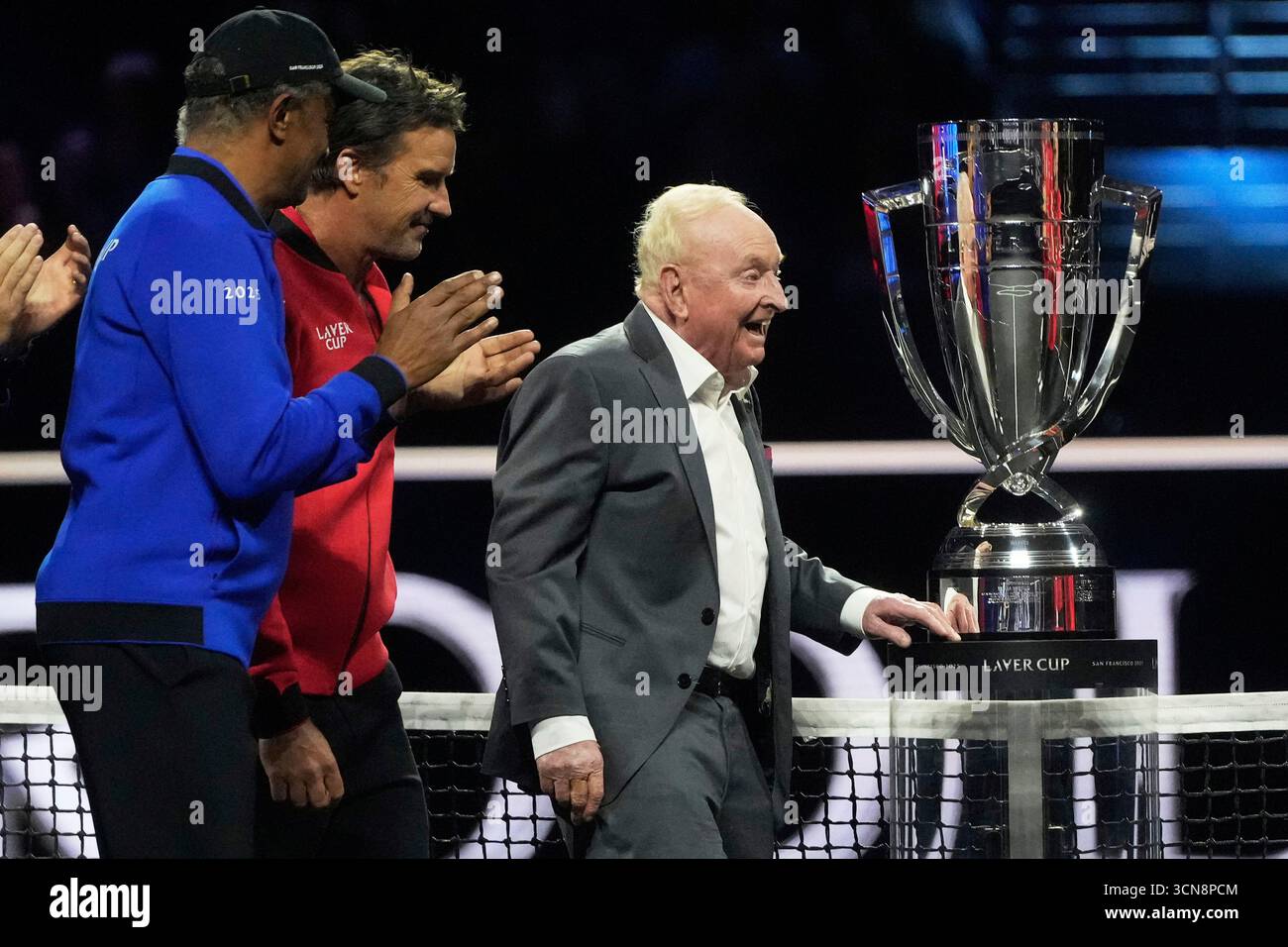 Rod Laver, right, smiles while walking past Team Europe captain Yannick ...