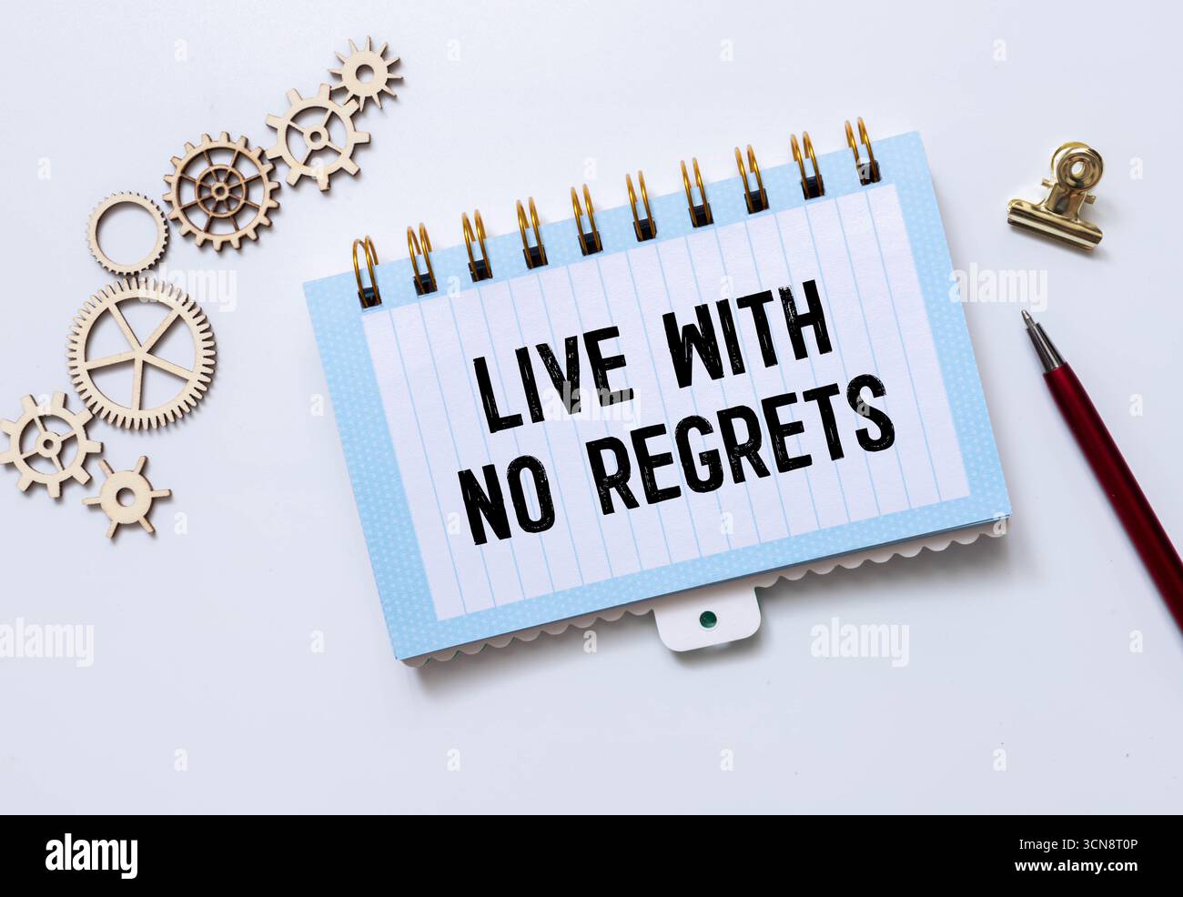 On blue background, torn paper with text written NO REGRET - to live a ...