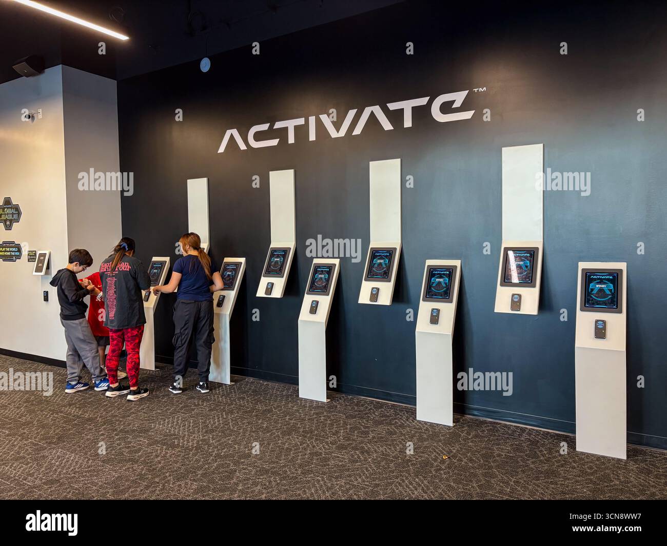 Guests interact with digital kiosks at an Activate immersive indoor ...