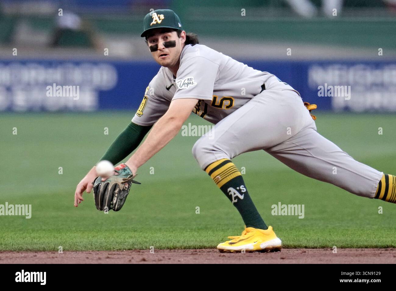 Athletics shortstop Jacob Wilson dives by can't reach a ball hit for a ...