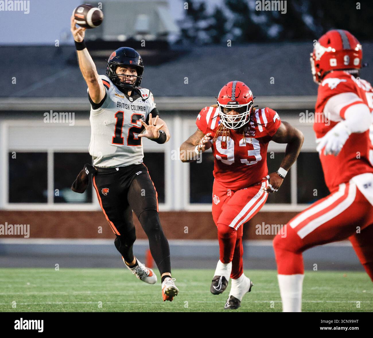 B.C. Lions quarterback Nathan Rourke, left, throws the ball as Calgary Stampeders' Charles Wiley ...