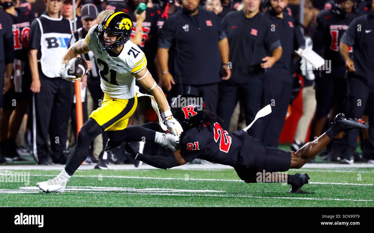 Iowa wide receiver Kaden Wetjen (21) breaks a tackle by Rutgers ...
