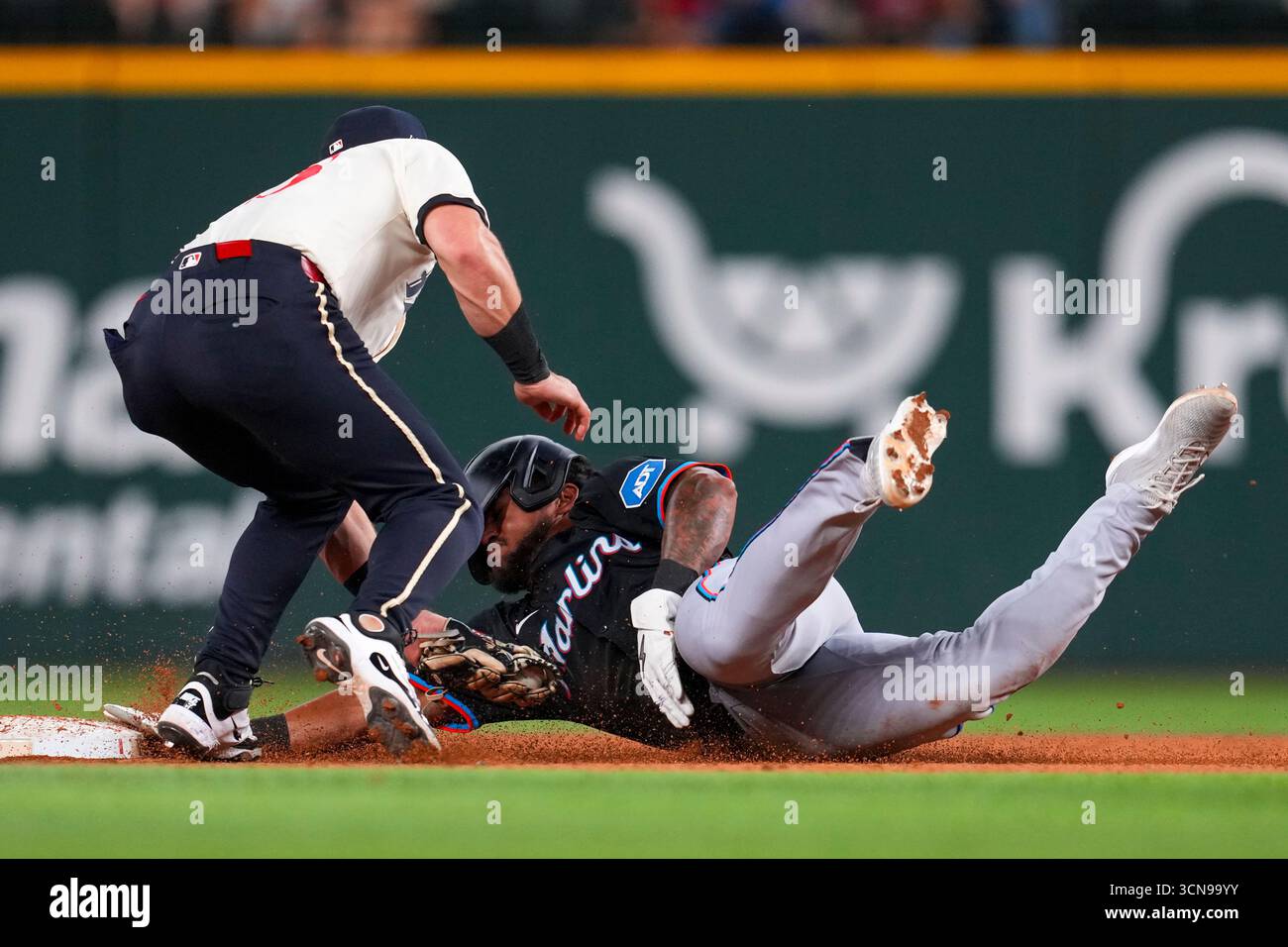 Miami Marlins' Dane Myers, right, steals second base head of the tag by ...