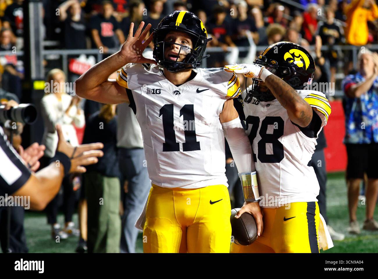 Iowa quarterback Mark Gronowski (11) reacts after scoring a touchdown ...