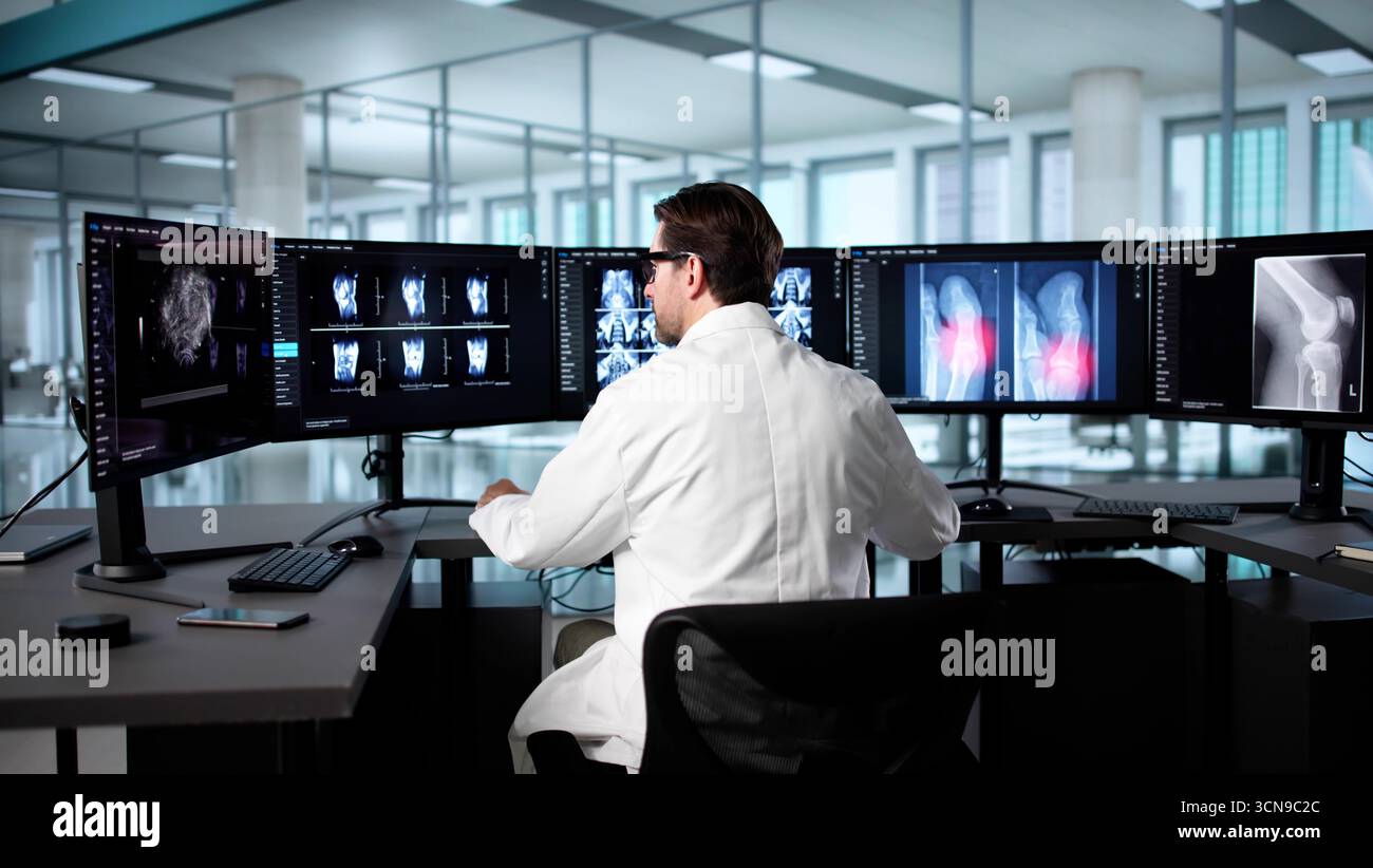 Senior Radiologist Analyzing X-Ray Image Of Elderly Man's Knee On ...