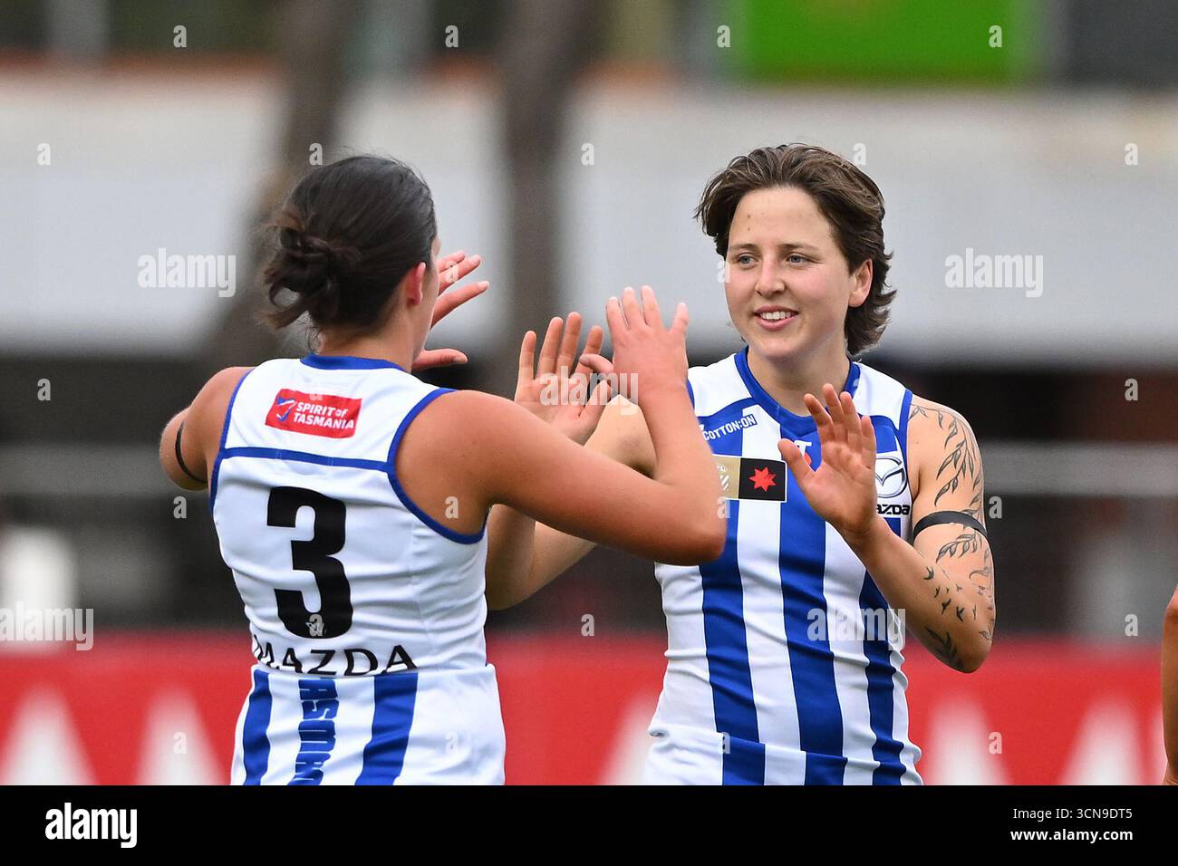 Tess Craven of the Kangaroos (right) celebrates with team mates after ...