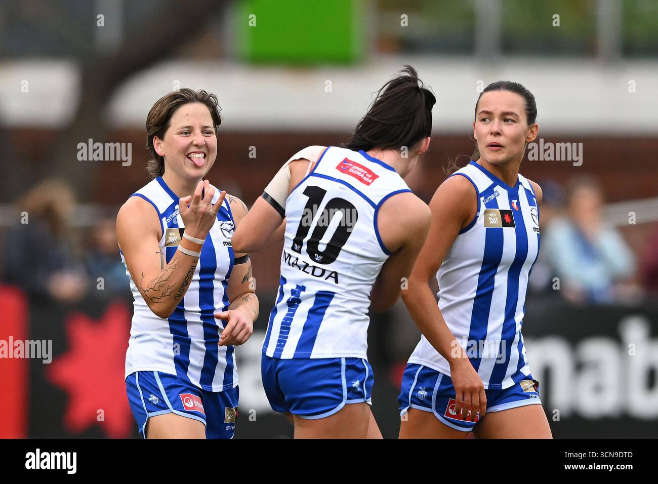 Tess Craven of the Kangaroos (left) celebrates with team mates after ...