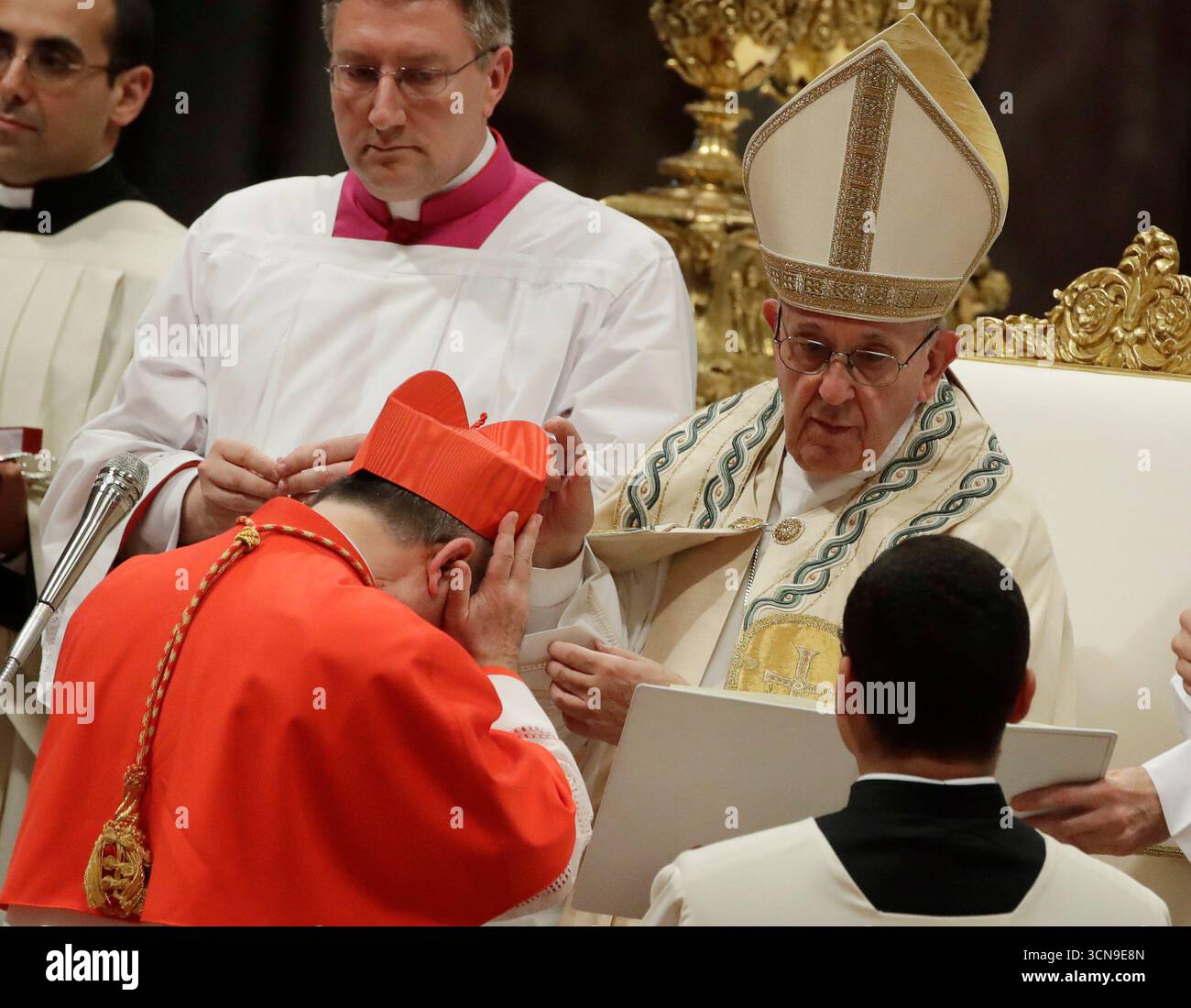 FILE - Cardinal Giovanni Angelo Becciu receives the red three-cornered ...