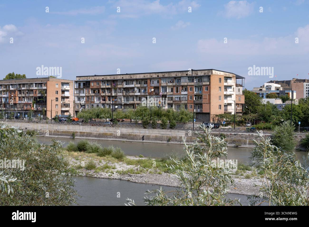 Soviet style housing buildings beside the Kura Rive in Gori, a Georgian ...